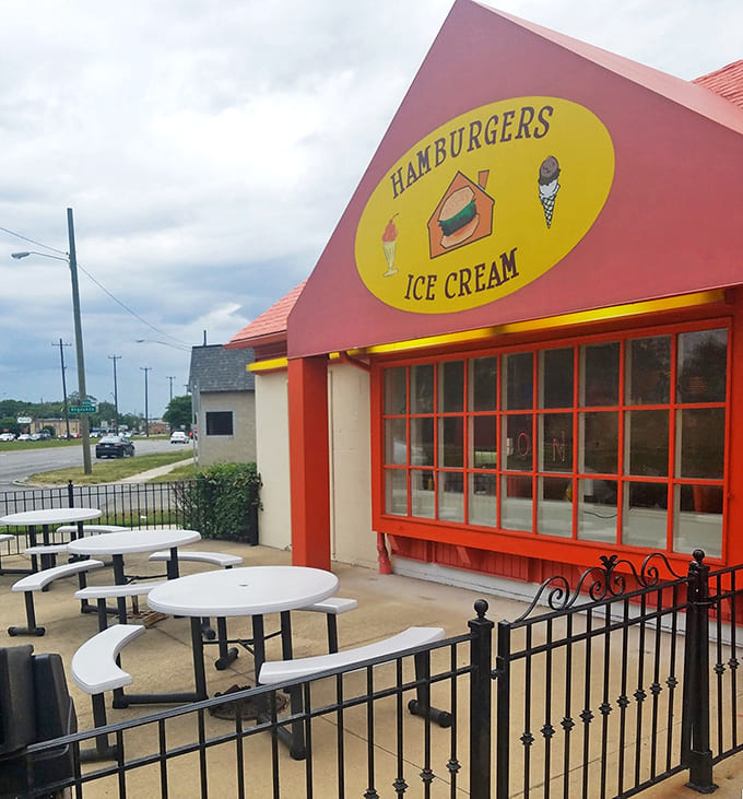 The Hut Diner's cheerful exterior beckons with its bright orange roof and yellow sign &ndash; a colorful promise of comfort food that never disappoints.