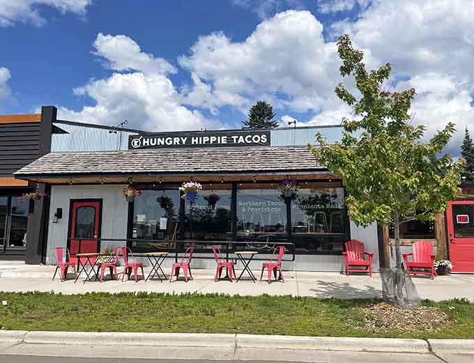 The bright red chairs outside Hungry Hippie Tacos aren't just seating, they're a promise of the colorful experience waiting inside.