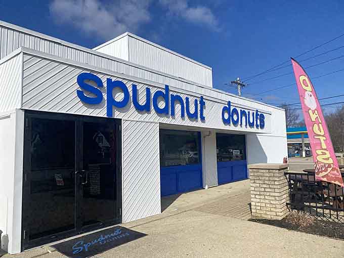 That crisp white exterior with bold blue letters means serious donut business is happening inside, no fancy frills required.