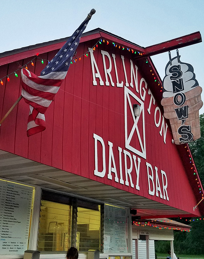 The iconic red barn structure stands proudly against the Vermont sky, its "SNOWS" sign promising frozen delights that generations have treasured.