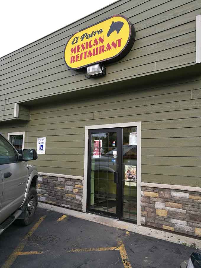 That cheerful yellow sign with the horse silhouette beckons hungry travelers off South Pokegama Avenue into chimichanga paradise.