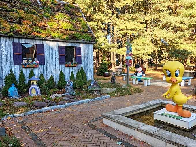 That weathered shed with the living roof looks like it's been growing there since fairy tales were invented, perfectly at home among the garden's whimsical charm.