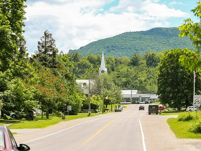 Vermont's quintessential charm captured in one frame: white church steeple, verdant mountains, and a main street that whispers "slow down."