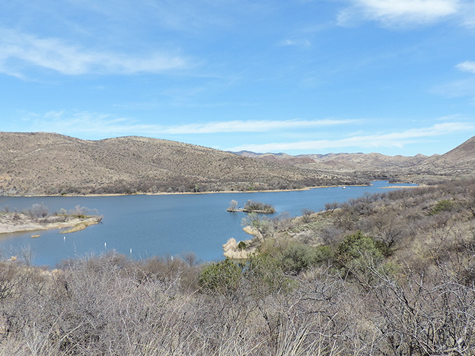 Soaring mountains frame the tranquil waters of Patagonia Lake, a desert oasis nestled among the rolling hills of southern Arizona.