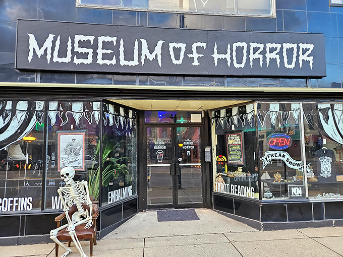 The ominous black facade with dripping white lettering welcomes brave souls to Monroe's Museum of Horror, where nightmares come alive.