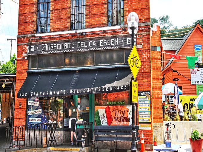 The iconic brick fa&ccedil;ade of Zingerman's Delicatessen stands proudly on Detroit Street, beckoning food lovers with its vintage charm and promise of culinary treasures within.