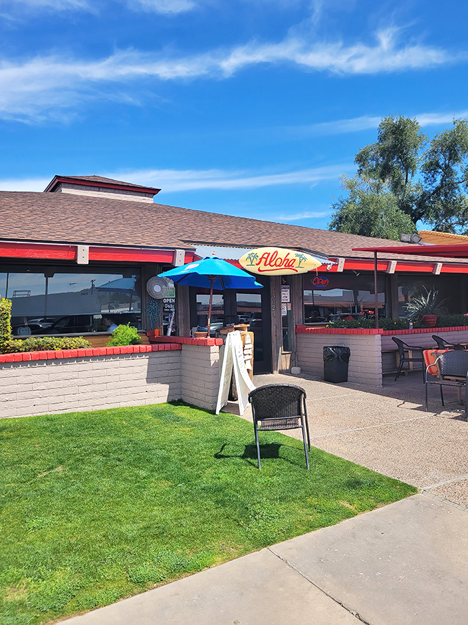 The welcoming exterior of Original Breakfast House beckons with its cheerful "Aloha" sign &ndash; a tropical promise in the Arizona desert.