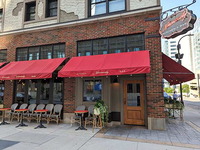 Those red awnings beckon like a lighthouse guiding hungry ships to shore, promising comfort food and good times inside.
