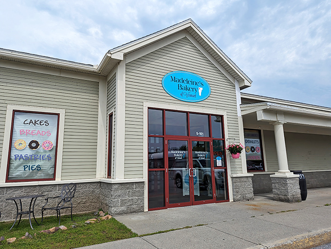 A charming Vermont welcome awaits at Madeleine's Bakery, where that turquoise sign promises sweet treasures inside.