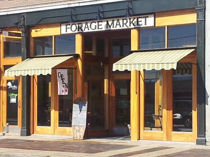 Forage Market's charming storefront welcomes visitors with wooden doors and classic striped awnings &ndash; an unassuming facade hiding bagel perfection within.