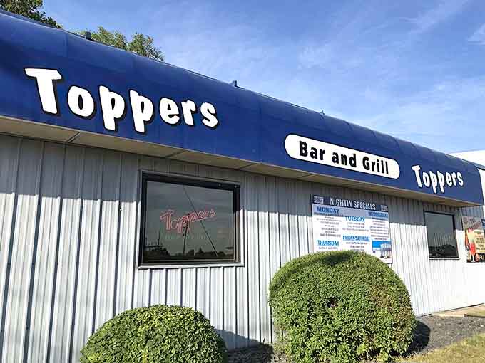 The unassuming blue exterior of Topper's Bar and Grill proves that the best meals don't need fancy facades to announce their greatness.