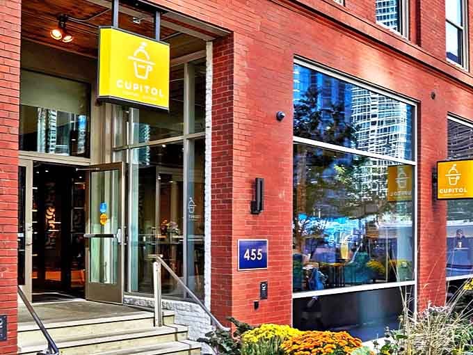 The bright yellow Cupitol sign beckons from the brick facade, promising coffee salvation to weary Chicago wanderers.