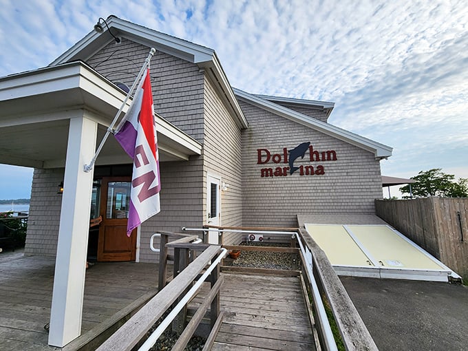 The weathered shingles and welcoming entrance of Dolphin Marina & Restaurant stand as a beacon for hungry travelers seeking authentic Maine flavors.