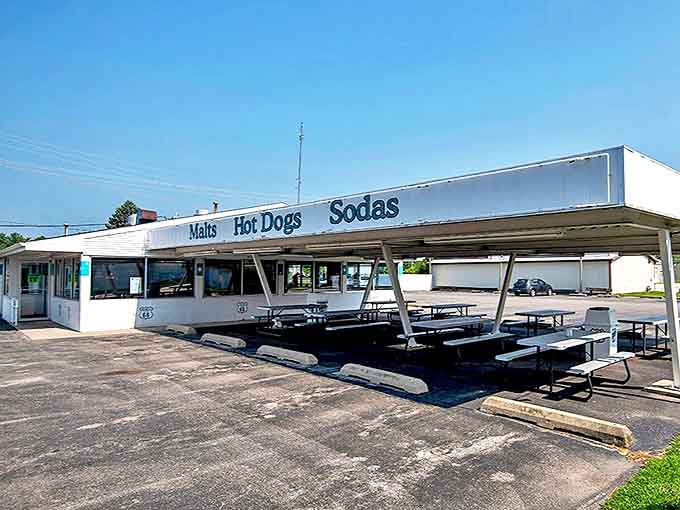 The iconic white exterior of Polk-A-Dot Drive In beckons travelers with its simple promise of "Malts, Hot Dogs, Sodas" &ndash; roadside Americana at its finest.