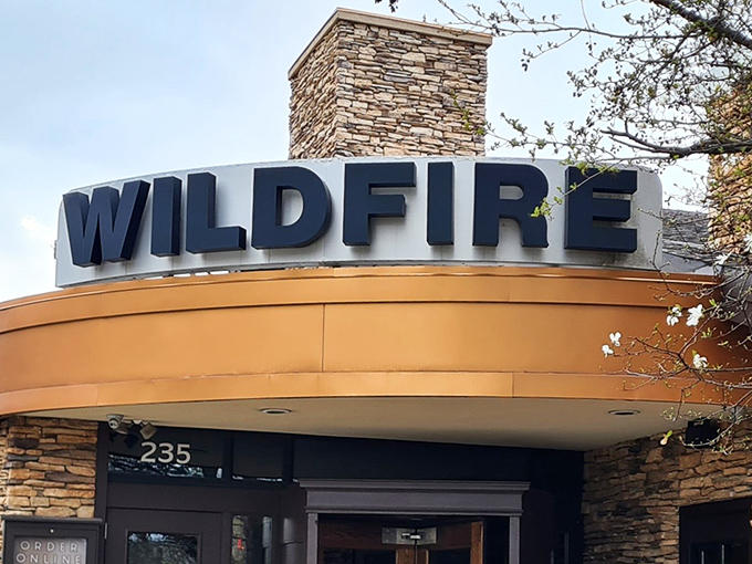 Wildfire's stone facade welcomes diners with rustic elegance, promising warmth inside that matches the glow of its signature sign.