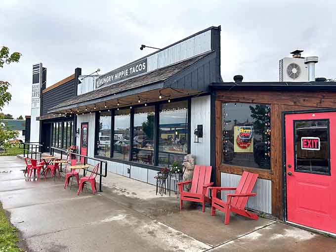 That cheerful red door and those bright chairs are your first hint that something special awaits inside this Grand Marais gem.