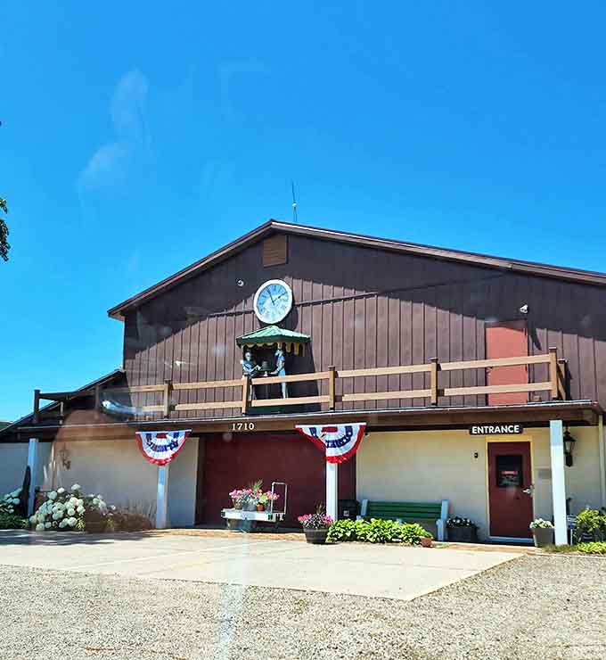 The Wheels O' Time Museum stands proudly against a brilliant blue Illinois sky, its rustic charm inviting visitors to step back into mechanical history.