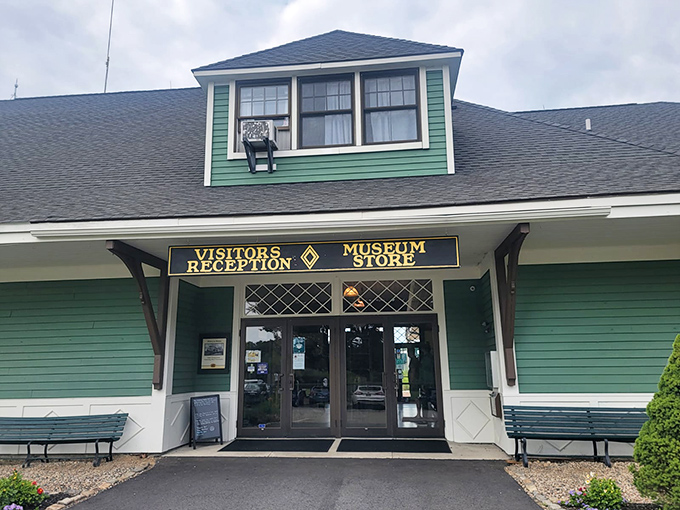 The welcoming green facade of the Seashore Trolley Museum's visitor center invites travelers to step back into the golden age of electric railways.