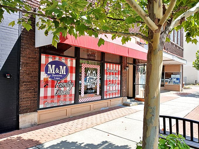 The classic red awning of M&M Family Diner beckons hungry travelers with promises of homestyle cooking and small-town charm.