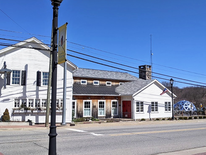 A storybook come to life! This charming white building with its red door is like a Norman Rockwell painting serving comfort food.