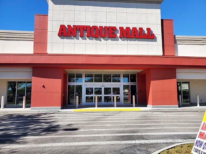 The bright red signage beckons like a lighthouse for treasure hunters, promising adventures in vintage collecting behind those modern doors.