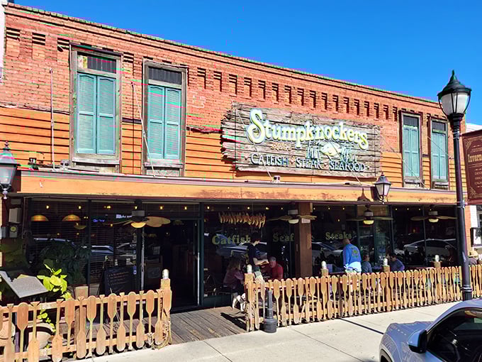 The iconic brick facade of Stumpknockers welcomes hungry visitors with its charming wooden sign and inviting outdoor seating area.
