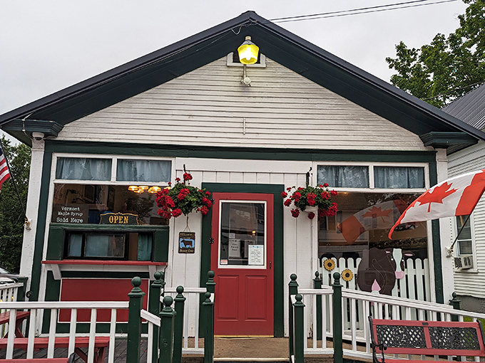The charming exterior of The Brown Cow welcomes visitors with its bright red door and quaint white picket fence.