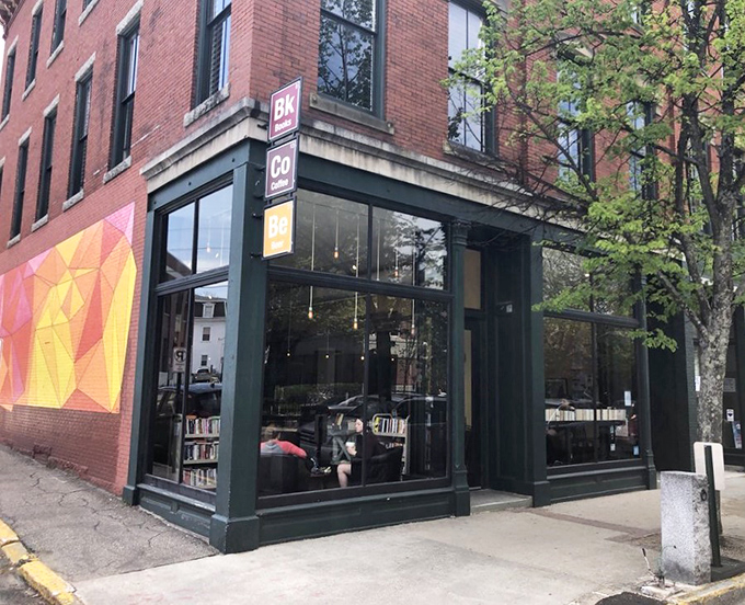 The corner brick building with its distinctive green trim houses a trifecta of life's essentials: books, coffee, and bagels.