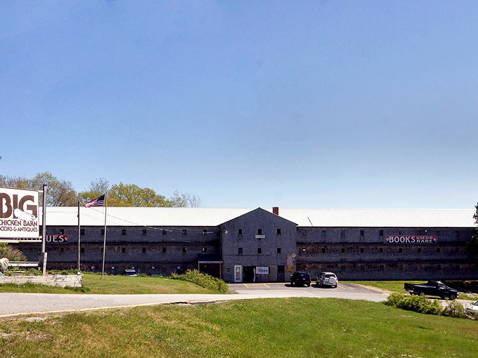 The imposing exterior of Big Chicken Barn Books & Antiques stretches along Route 1, its weathered charm inviting curious travelers to explore what lies within.
