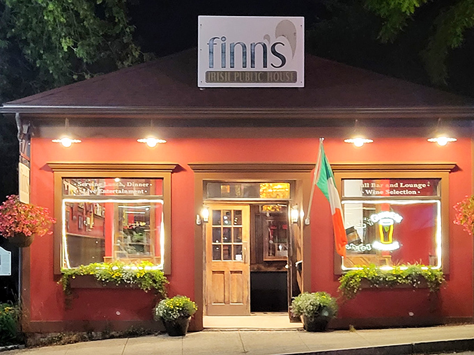 The welcoming crimson facade of Finn's Irish Public House glows invitingly at dusk, like a warm hearth on a cold Maine evening. 