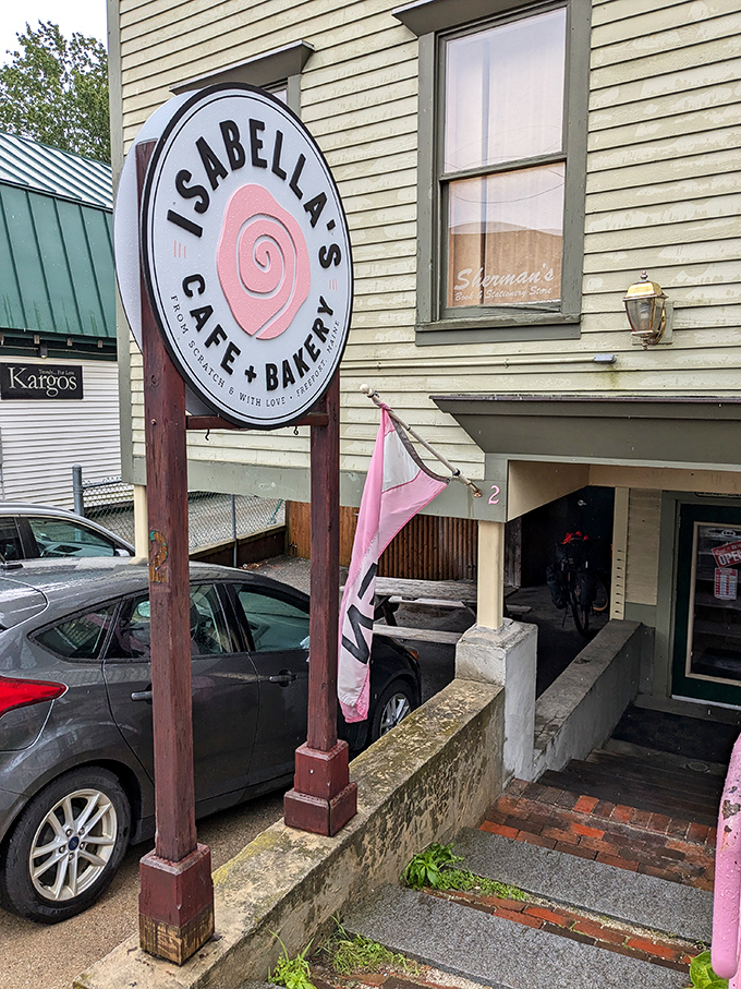 That pink swirl logo beckons you down the stairs like a breakfast siren song you absolutely want to follow.