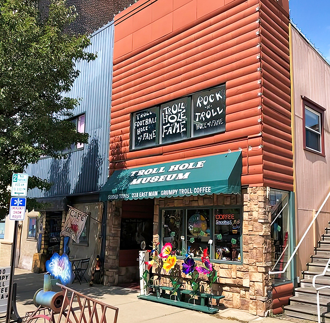 The vibrant orange exterior of The Troll Hole Museum stands out in downtown Alliance like a beacon of whimsical nostalgia.