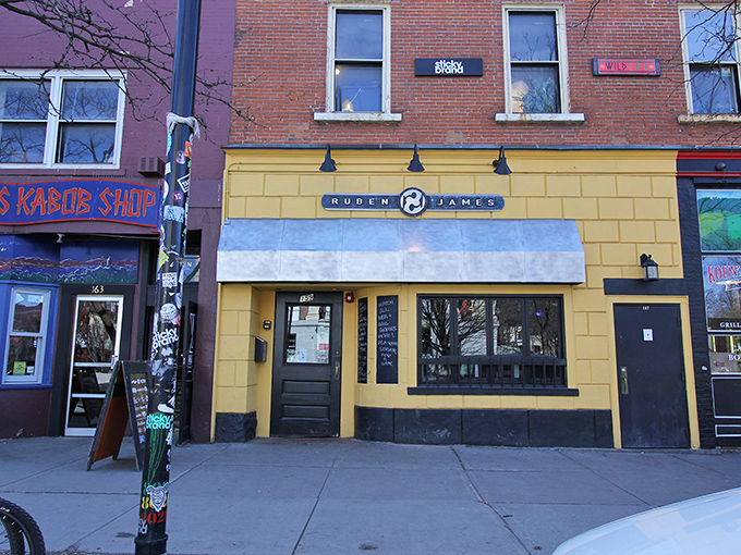 The cheerful yellow exterior of Ruben James stands out on Burlington's street, a beacon of burger brilliance hiding in plain sight.