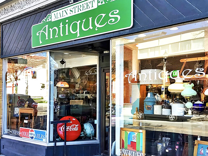 The iconic green sign of Main Street Antiques beckons from its historic brick building, promising treasures within for the curious explorer.