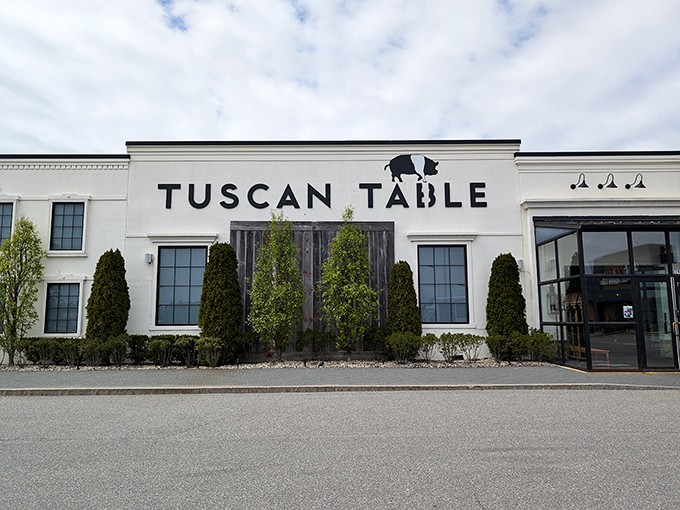 Tuscan Table's elegant white exterior with its distinctive pig silhouette logo promises an Italian experience that's both sophisticated and playful.