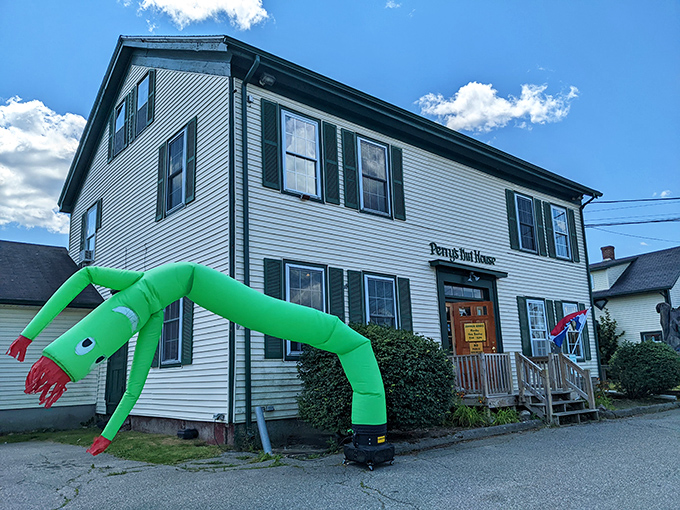 Perry's Nut House welcomes visitors with classic New England charm and a surprisingly enthusiastic green tube man &ndash; Maine hospitality at its quirkiest!