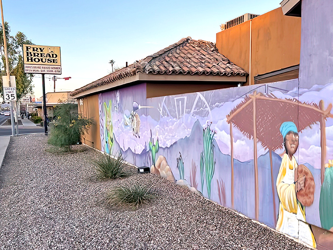 The unassuming exterior of Fry Bread House, with its vibrant murals and desert landscaping, belies the culinary treasures waiting inside.