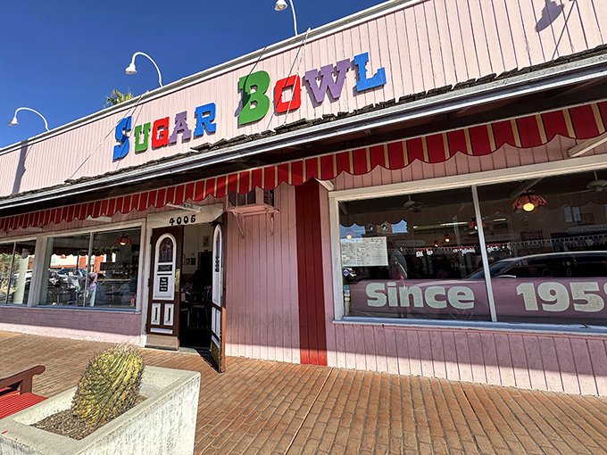 The iconic pink exterior of Sugar Bowl beckons with its playful, multicolored lettering &ndash; a sweet beacon in Old Town Scottsdale since 1958.