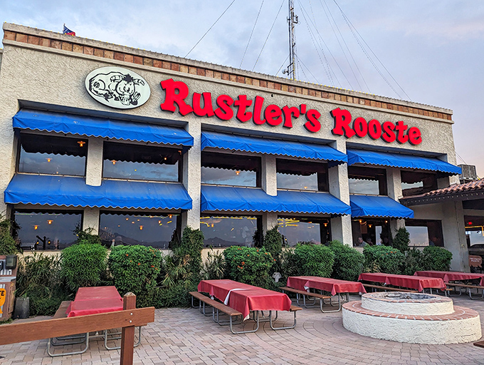 Rustler's Rooste stands proud against the Arizona sky, its blue awnings and bold red sign promising Western adventures and hearty meals within.