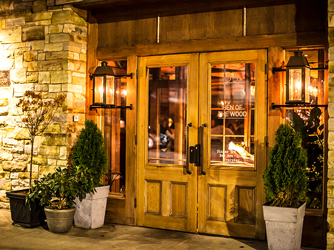 Warm wooden doors flanked by stone walls welcome you to Hen of the Wood, where rustic Vermont charm meets culinary excellence.