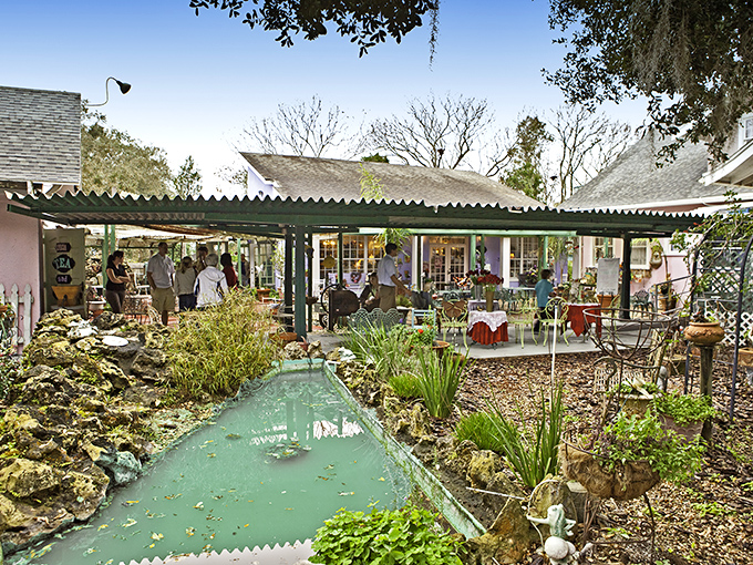 A charming cottage exterior welcomes visitors with lush gardens and a serene pond, creating an instant escape from the everyday world.