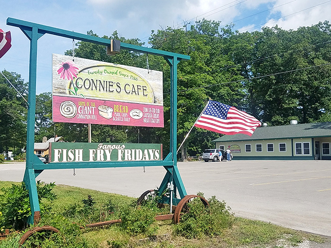 Connie's welcoming roadside sign stands proudly with its American flag, promising culinary treasures that have delighted locals since 1980.