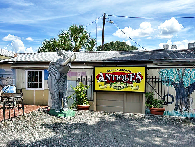 The unassuming exterior of Olde Inverness Antiques, where that trumpet-blowing elephant statue practically screams "quirky treasures inside!" Florida charm at its finest.