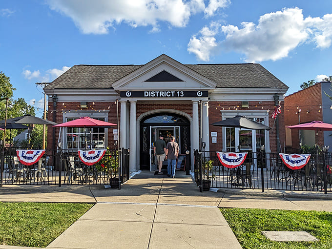 District 13's stately brick exterior with patriotic bunting welcomes hungry visitors to this Sunbury gem, where unpretentious charm meets culinary excellence.