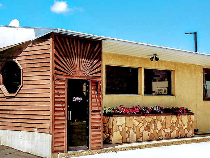 De Toy's distinctive sunburst wooden facade stands like a beacon for hungry travelers, promising comfort food and small-town charm inside.