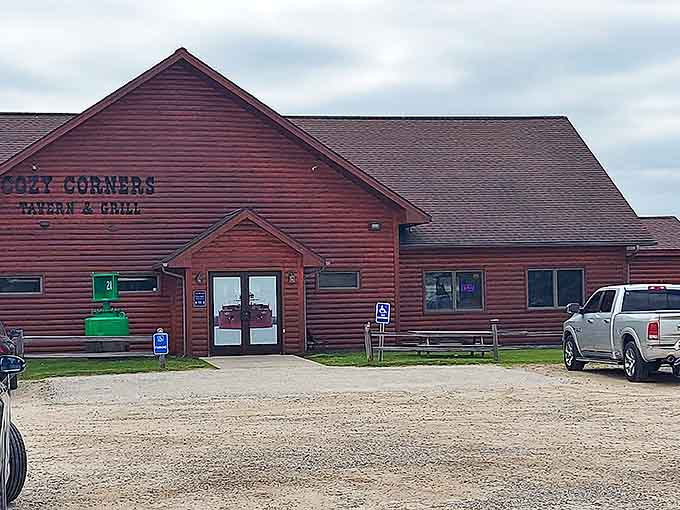 Cozy Corners Tavern & Grill welcomes hungry travelers with its rustic log cabin charm, promising comfort food that'll make you forget all your worries.
