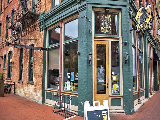 A green-painted brick corner building houses HopCat, where comfort food dreams come true in downtown Grand Rapids.
