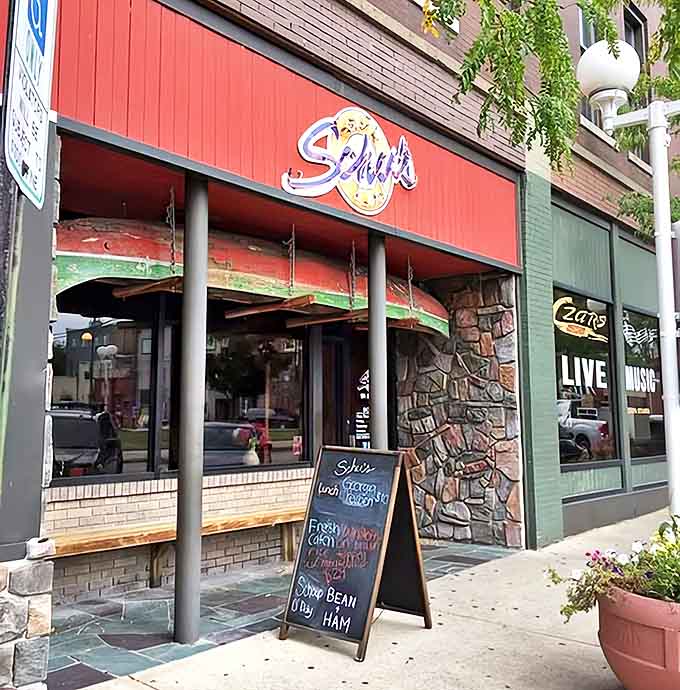 Schu's Grill & Bar welcomes hungry visitors with its distinctive red storefront and vintage signage, promising culinary treasures within this St. Joseph landmark.