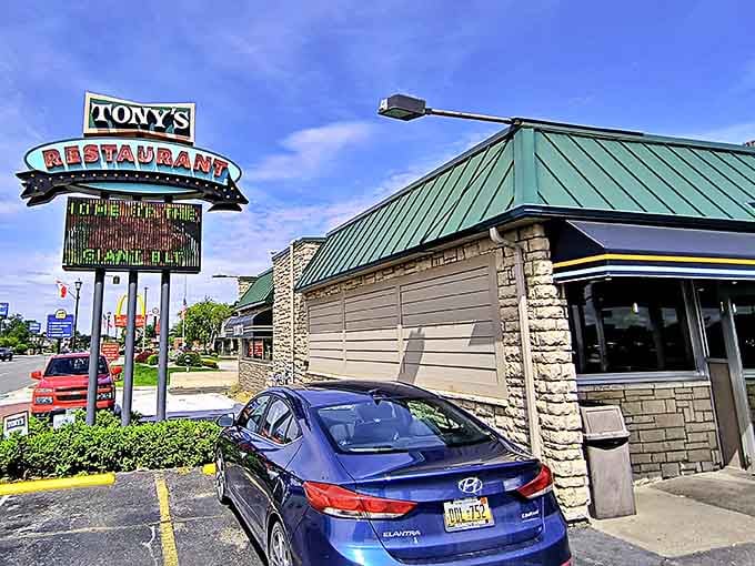 That retro sign beckons hungry travelers like a delicious lighthouse guiding ships to bacon-filled shores.