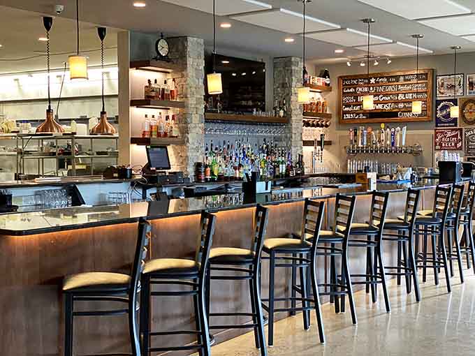 The bar area gleams with promise, featuring an impressive tap selection and enough spirits to satisfy any cocktail craving imaginable.